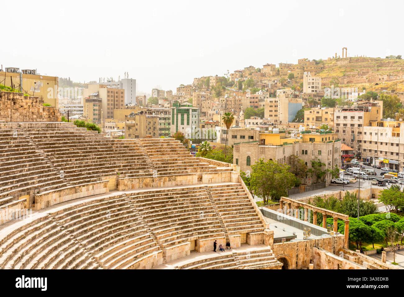 Ancient Roman amphitheater and many residential houses on the hills in ...