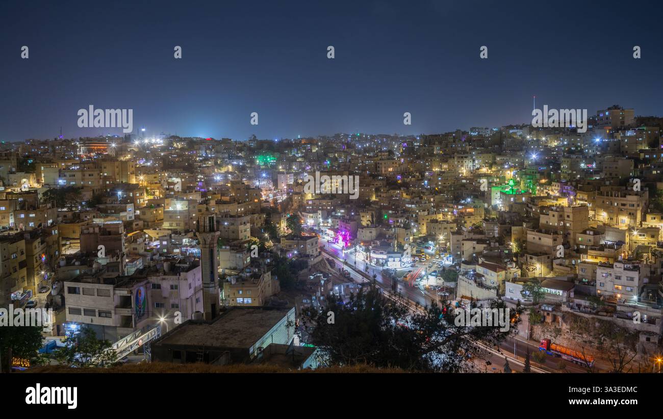Night panorama of Amman city downtown with lots of glowing streets and ...