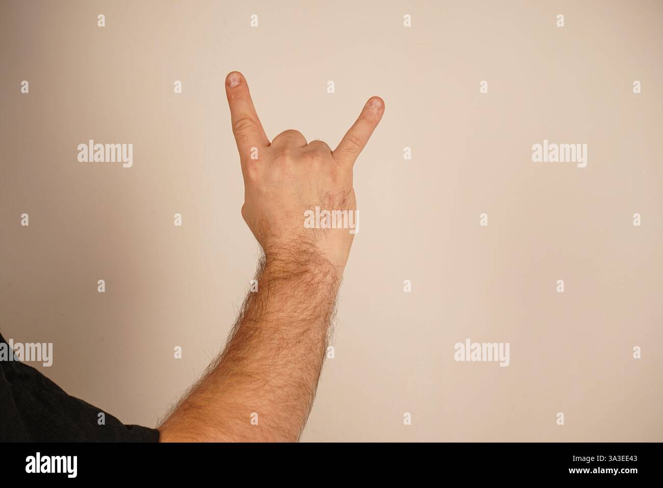 Index and pinky fingers are raised in a striking pose. This universal ...