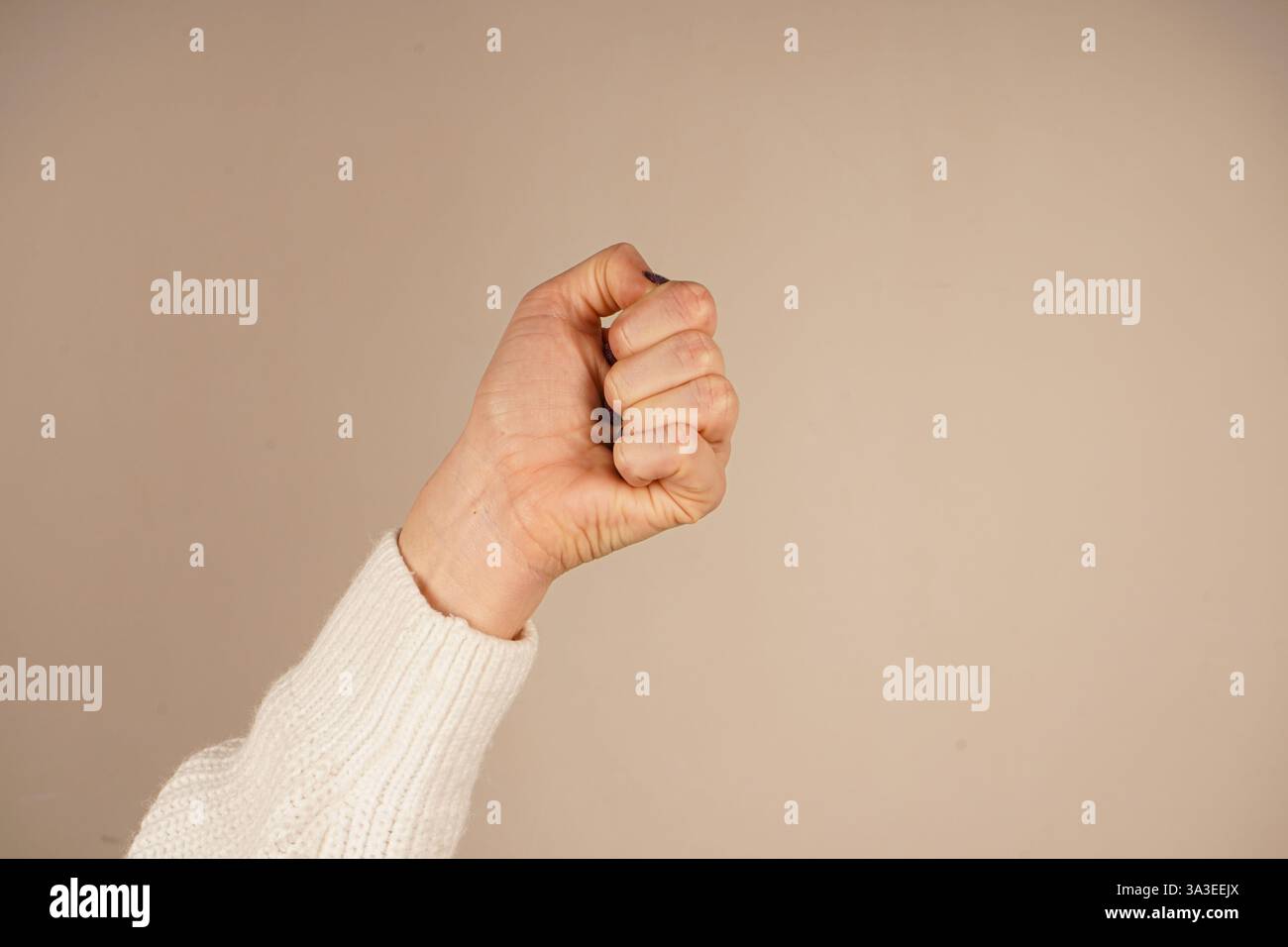 A clenched fist symbolizes strength, resistance, or determination. The ...