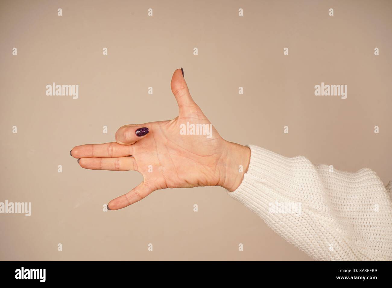 The hand gesture mimics the open mouth of a dog, combining whimsy and ...
