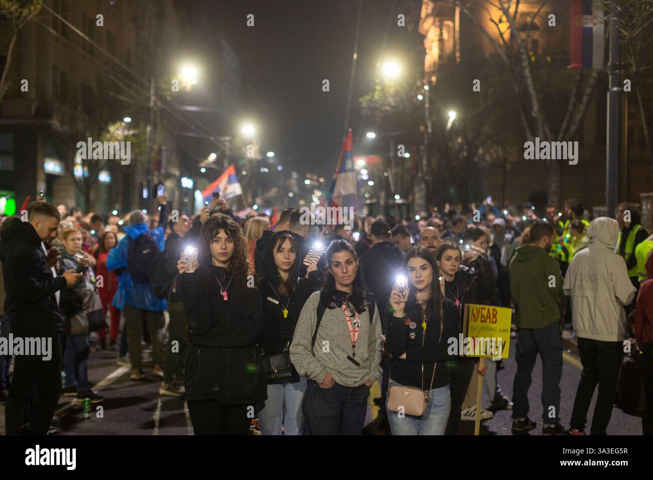 People use the lights on their cell phones as they observe fifteen ...