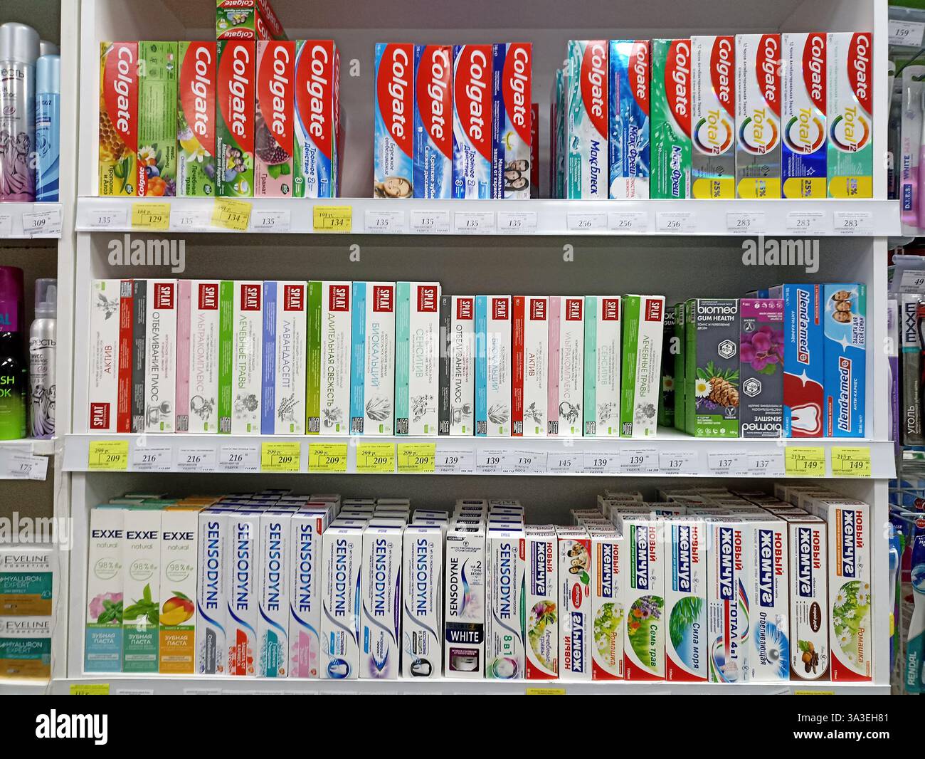 Variety of toothpaste brands on store shelves with colgate oral-b blend ...