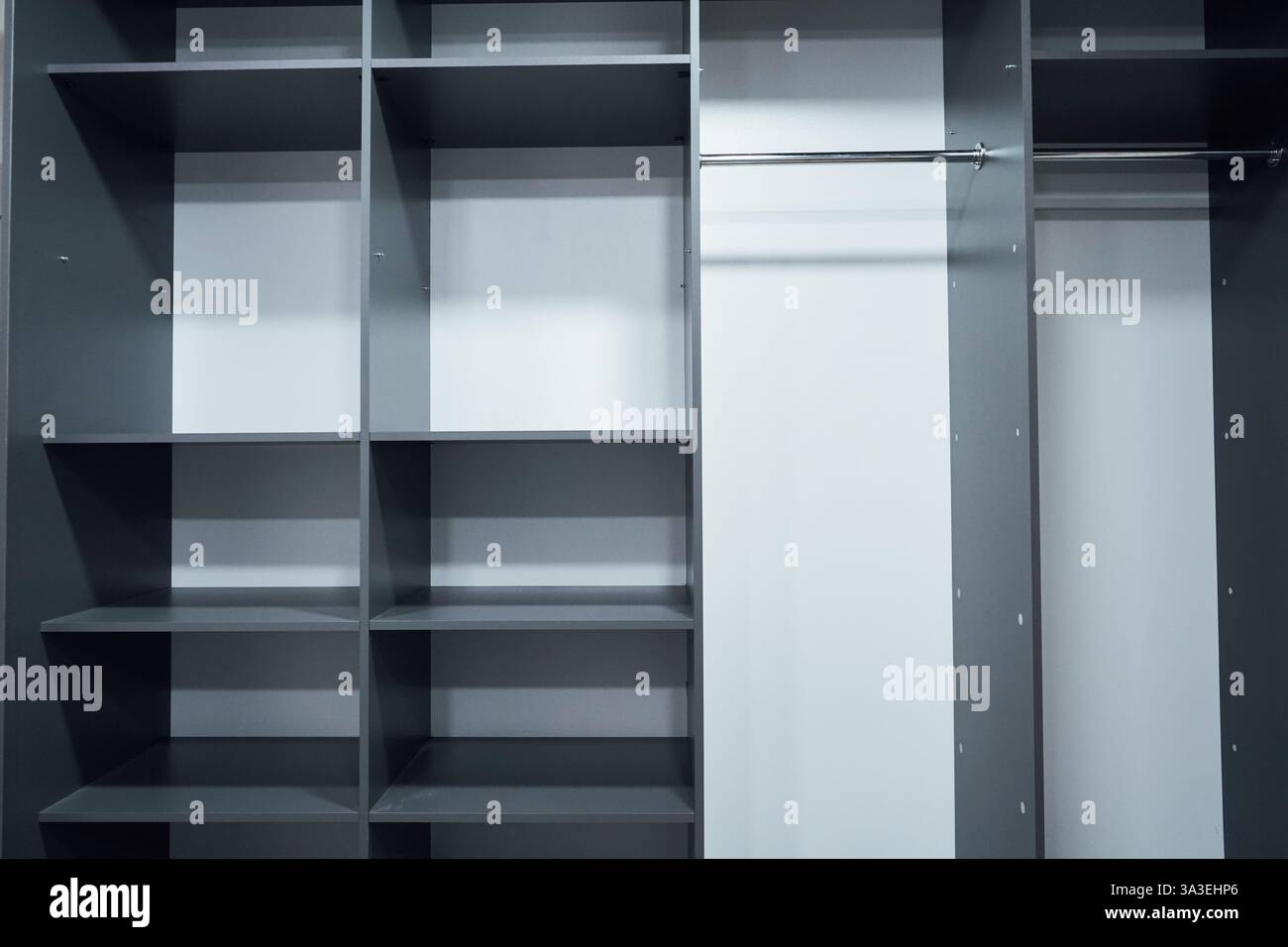 Open gray wardrobe with shelves and storage, minimalist design Stock ...
