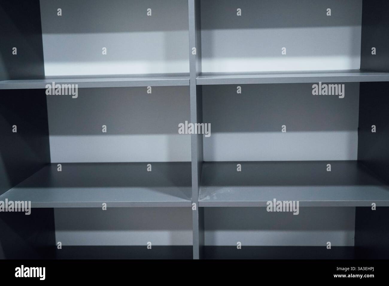 Open gray wardrobe with adjustable shelves, showing off the empt Stock ...