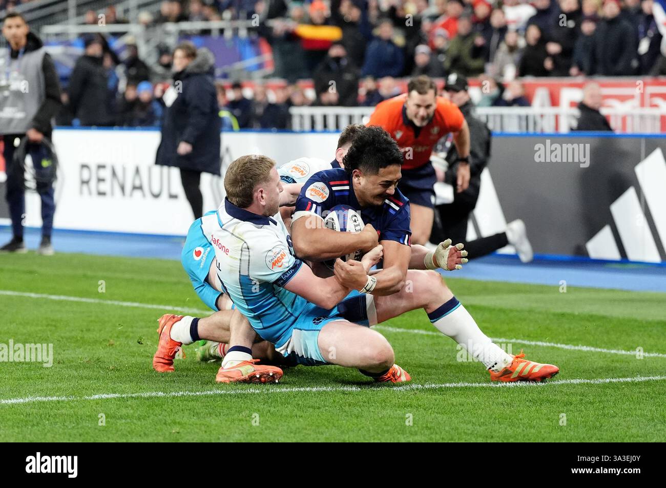 France's Yoram Moefana (second right) scores a try during the Guinness Men's Six Nations match ...