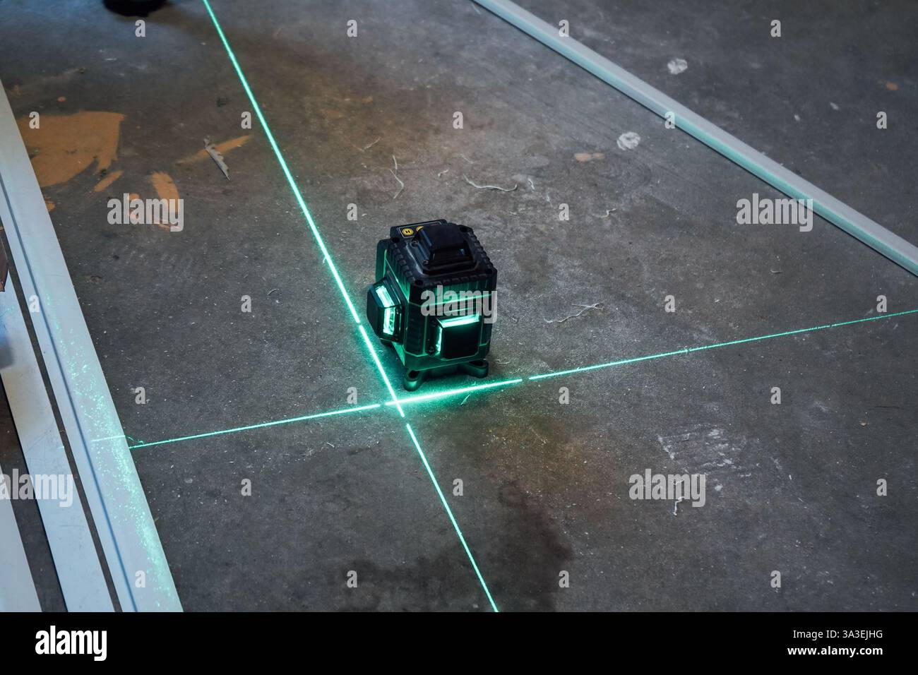 The laser level projects two perfectly aligned green beams onto the ...