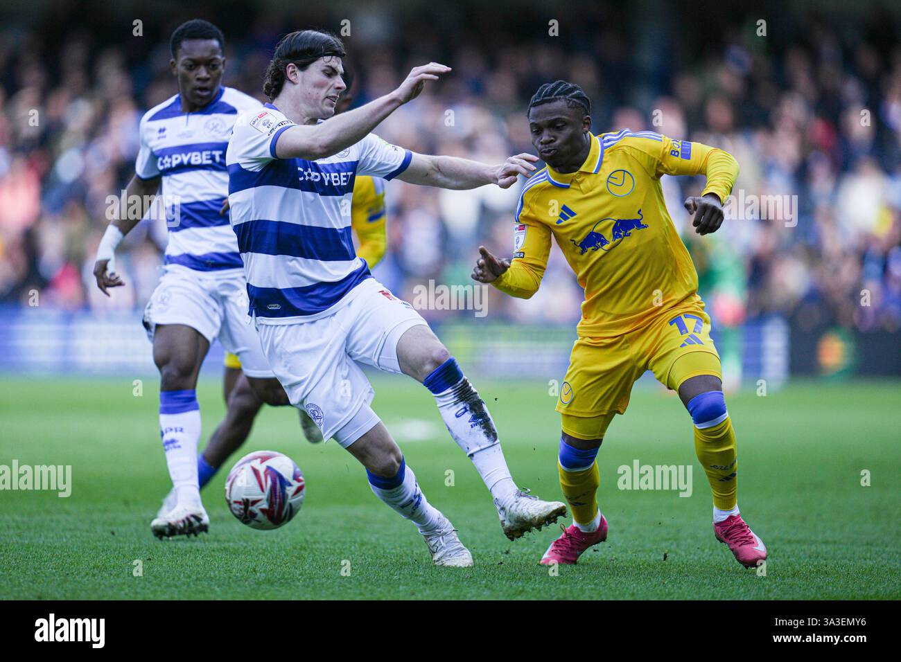 Ronnie Edwards of Queens Park Rangers blocks Largie Ramazani of Leeds ...