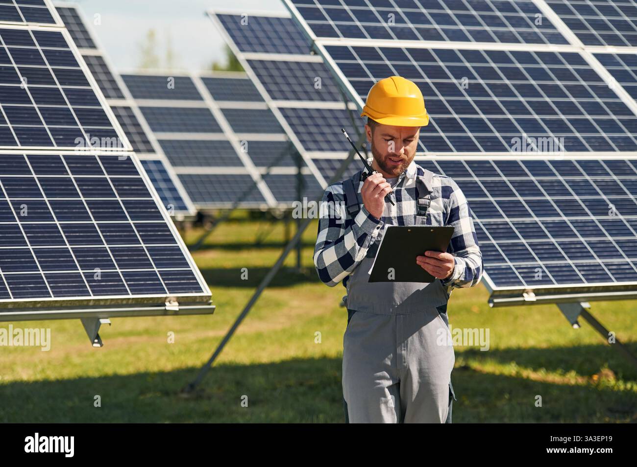 Communication by using walkie talkie. Engineer with photovoltaic solar ...