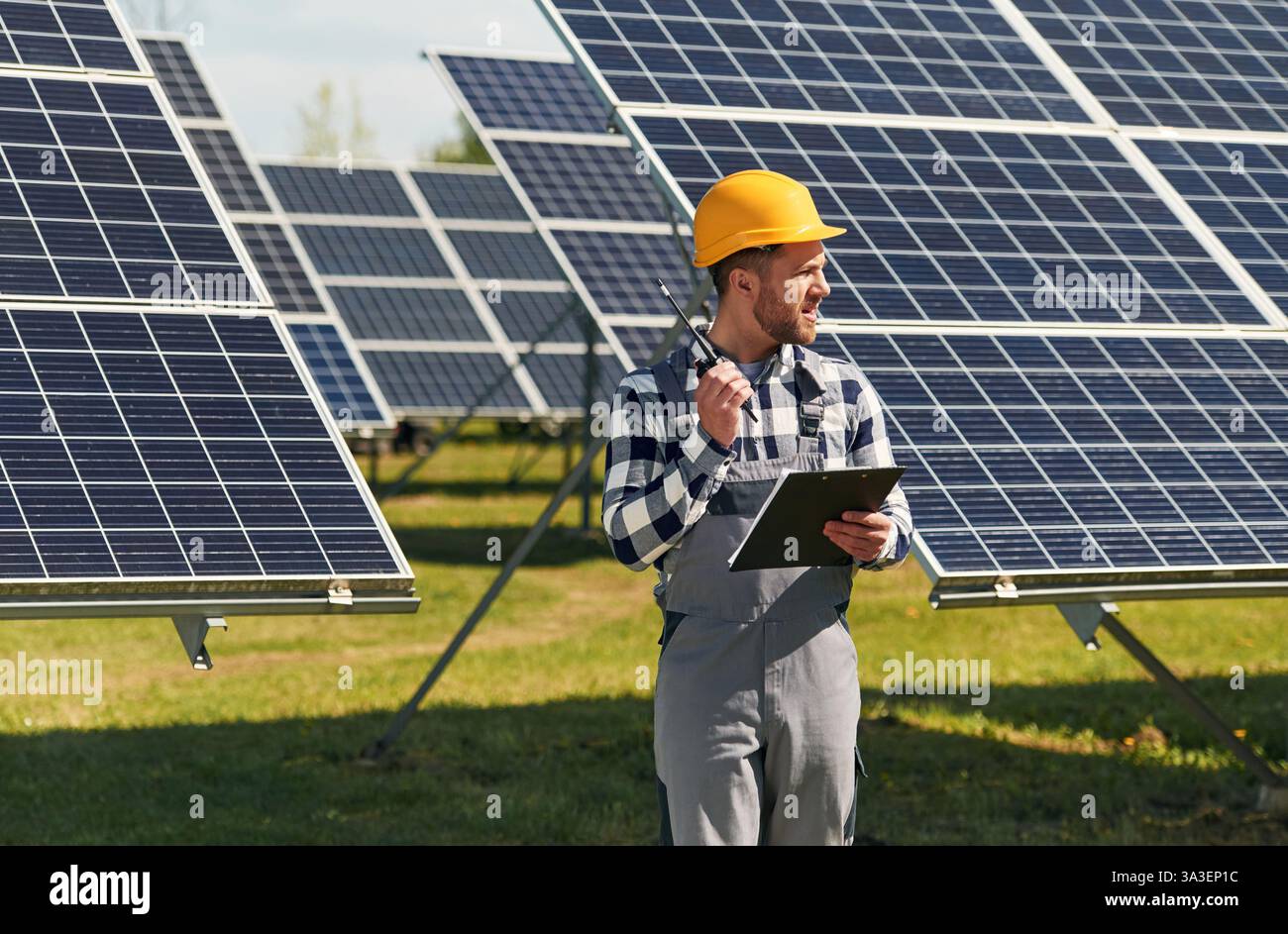 Communication by using walkie talkie. Engineer with photovoltaic solar ...
