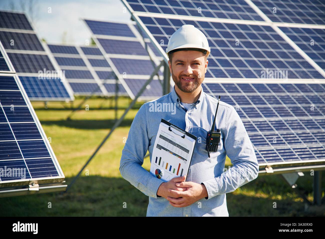 Professional adult engineer with photovoltaic solar panels outdoors at ...