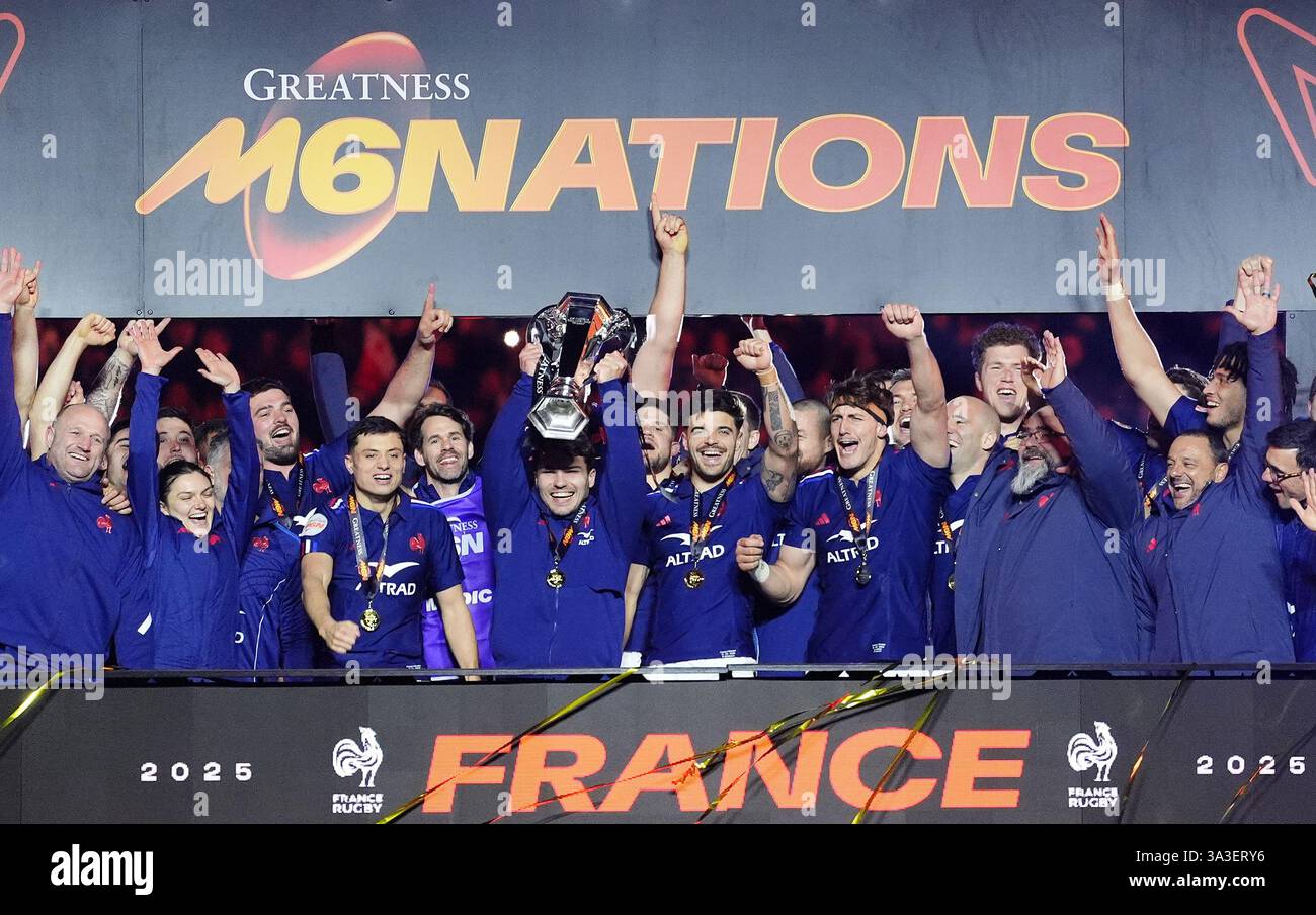 France's Antoine Dupont lifts the Guinness Men's Six Nations Championship trophy after winning ...