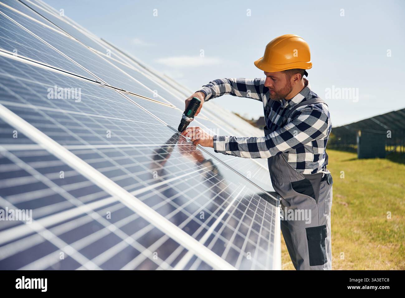 Installation process, with drill. Engineer with photovoltaic solar ...