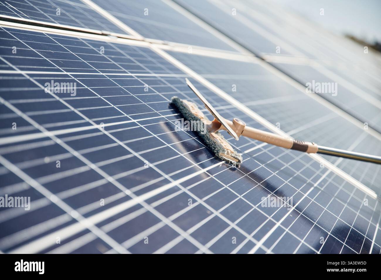 Close up view of cleaning solar panels surface Stock Photo - Alamy