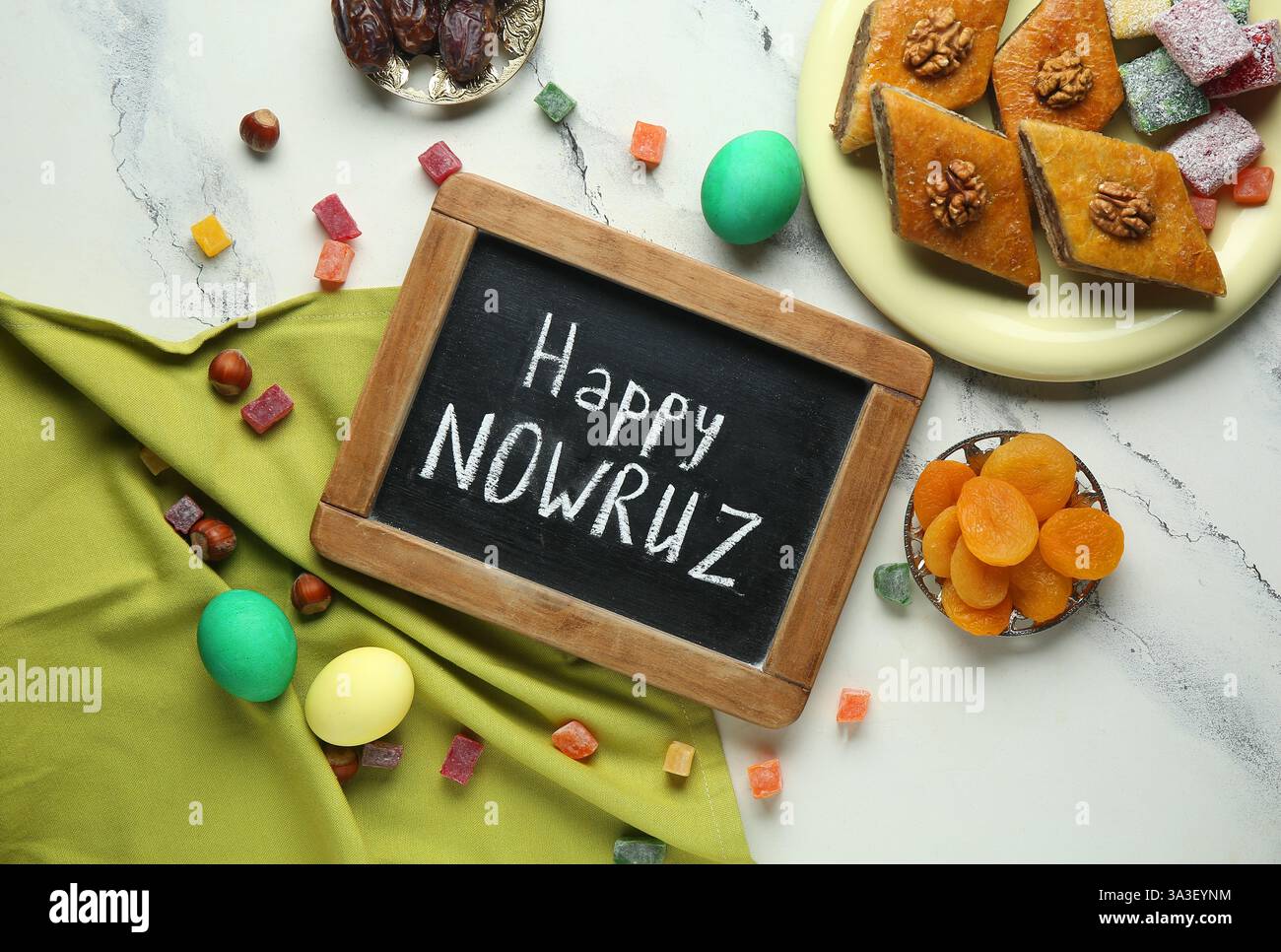Chalkboard with text HAPPY NOWRUZ and traditional sweets on white ...