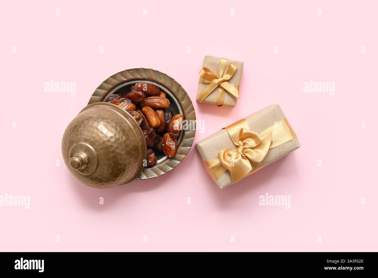 Dates and gift boxes on pink background. Ramadan celebration Stock ...