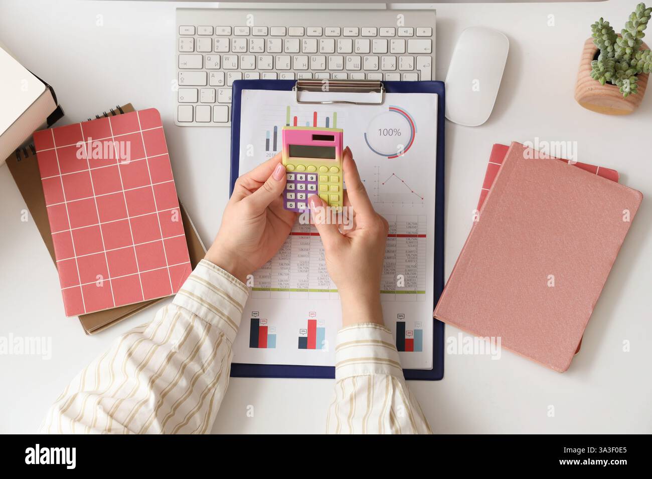 Female accountant with calculator, notebooks, keyboard and financial ...