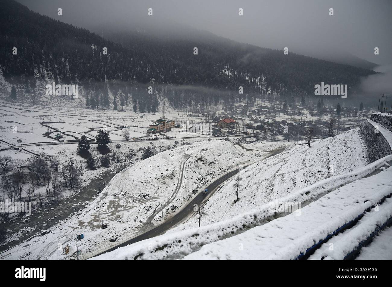 SRINAGAR, INDIA - MARCH 15: A view of a snow covered village at ...