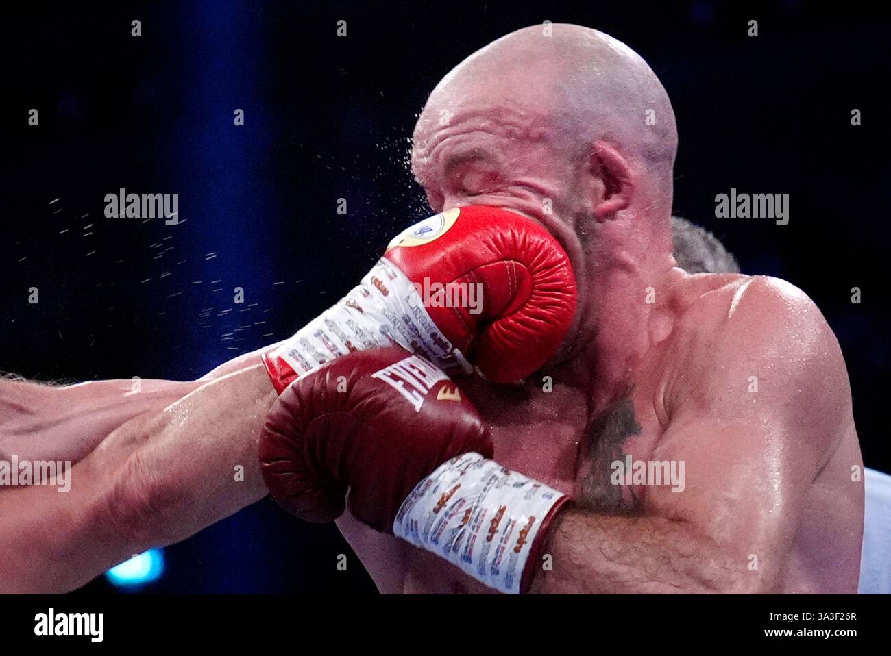 Nick Ball (left) defending his Featherweight WBA title lands a punch on ...