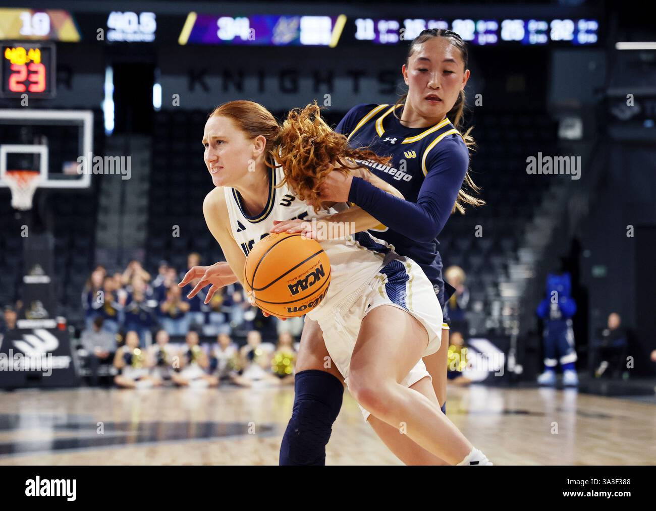 UC Davis Aggies guard Sydney Burns (13) and UC San Diego guard Sabrina ...