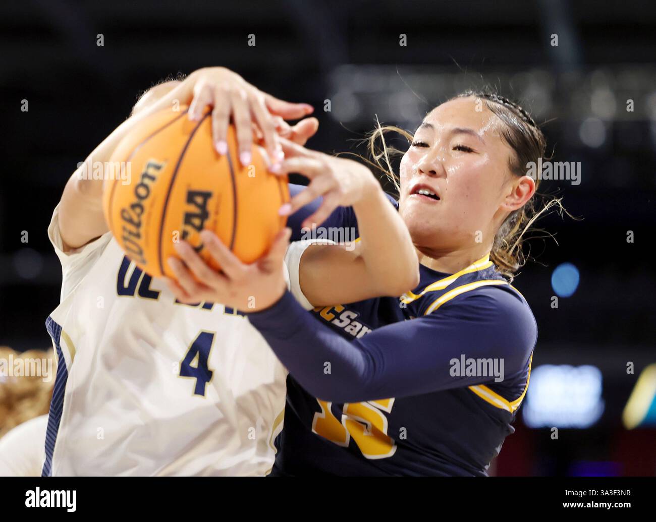 UC San Diego guard Sabrina Ma (15) and UC Davis guard Nya Epps (4) go ...
