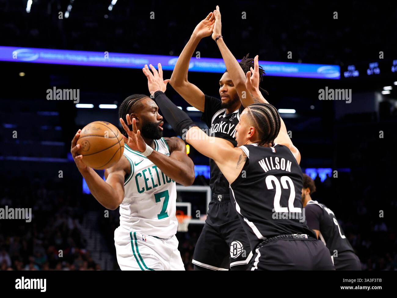 Brooklyn Nets' Ziaire Williams and Jalen Wilson (22) defend against ...