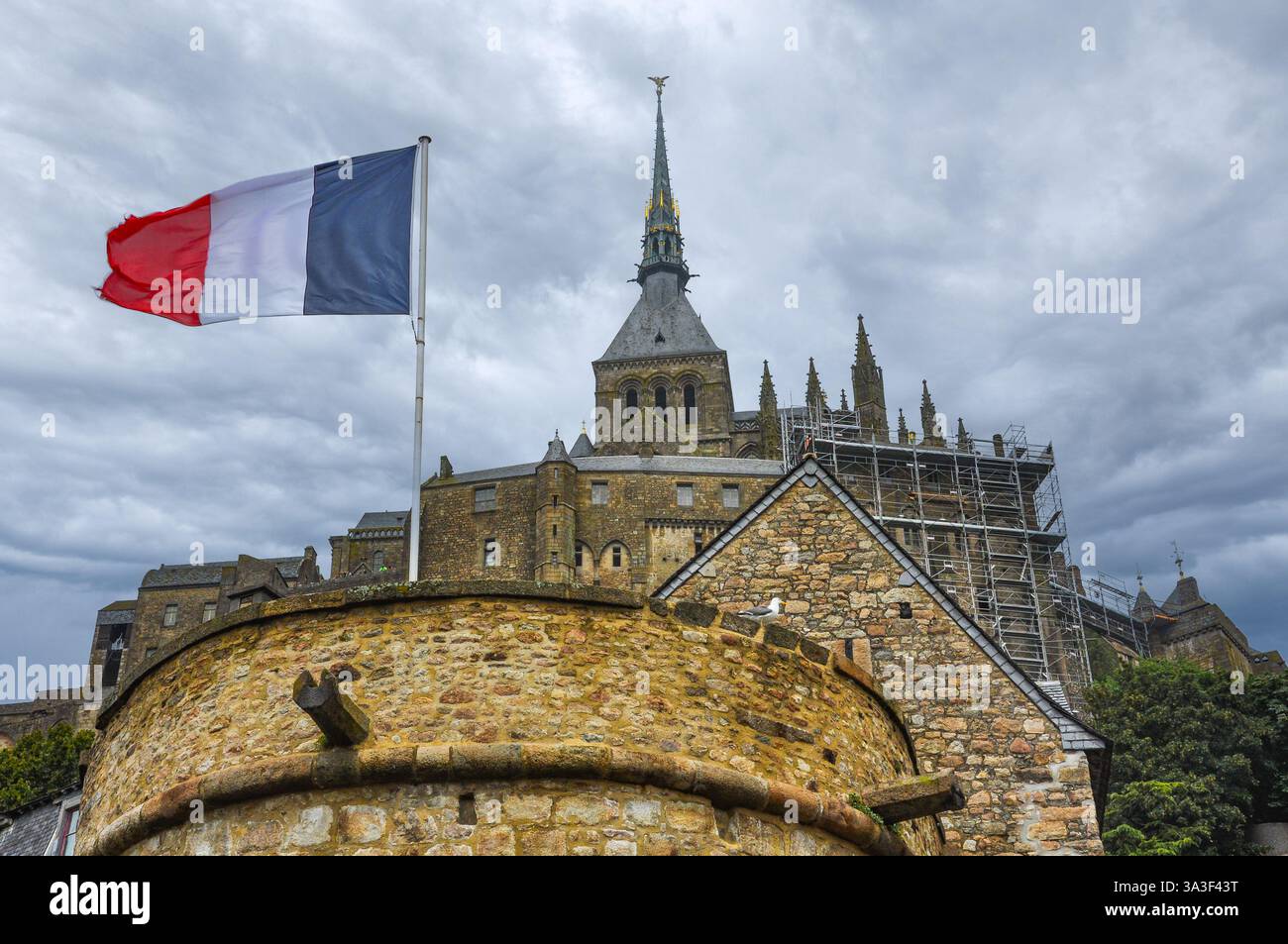 A View of Mont Saint Michel with French Flag Waving Proudly, Normandy ...