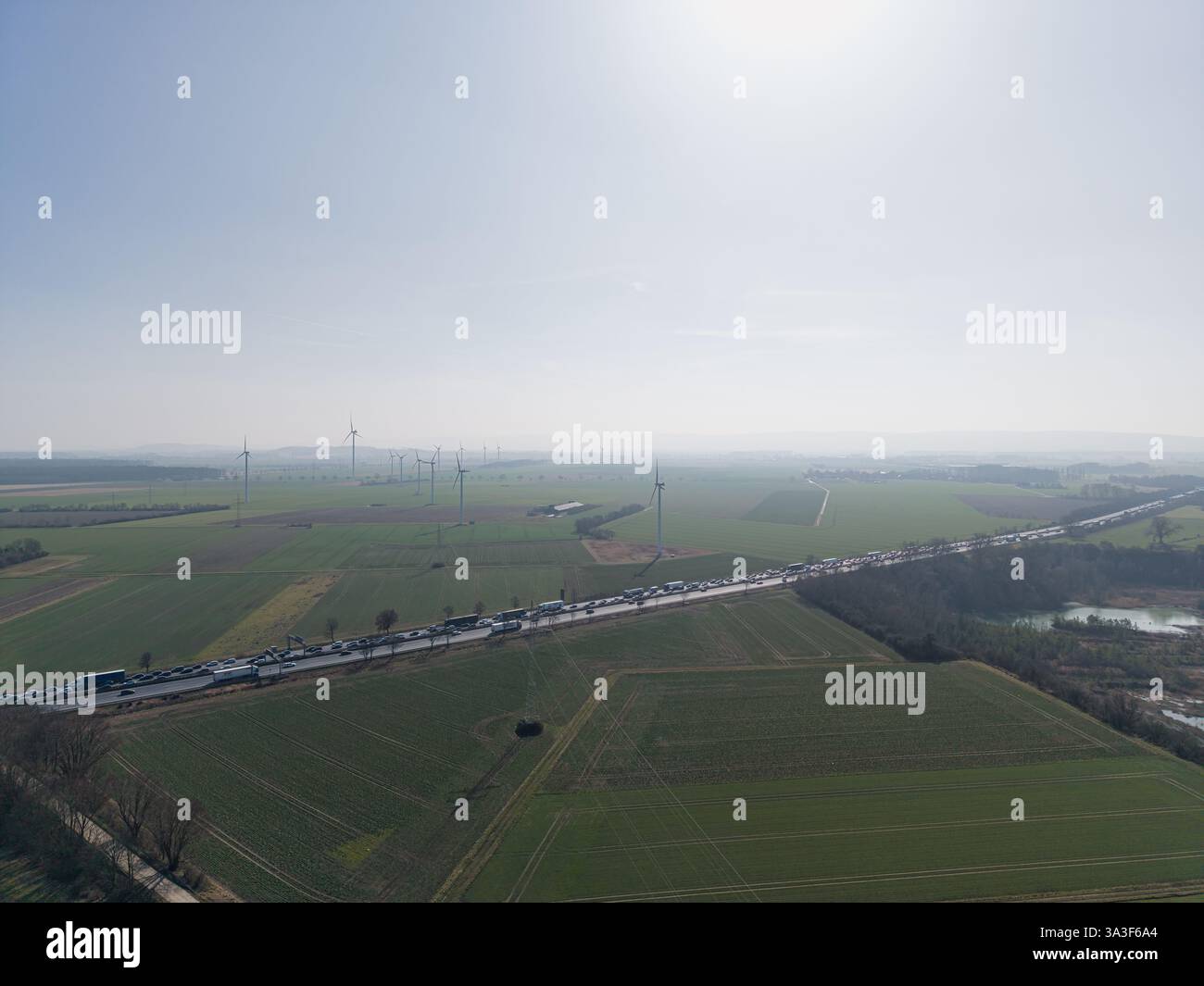 An expansive aerial shot captures vast green fields along with an ...