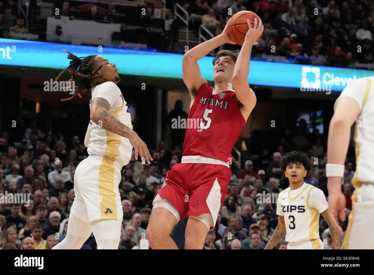 Miami Ohio guard Peter Suder (5) shoots over Akron guard Shammah Scott ...