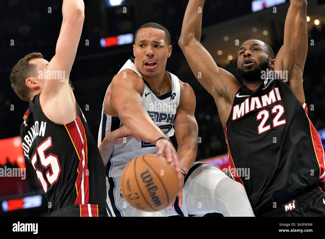 Memphis Grizzlies guard Desmond Bane, center, passes the ball between ...