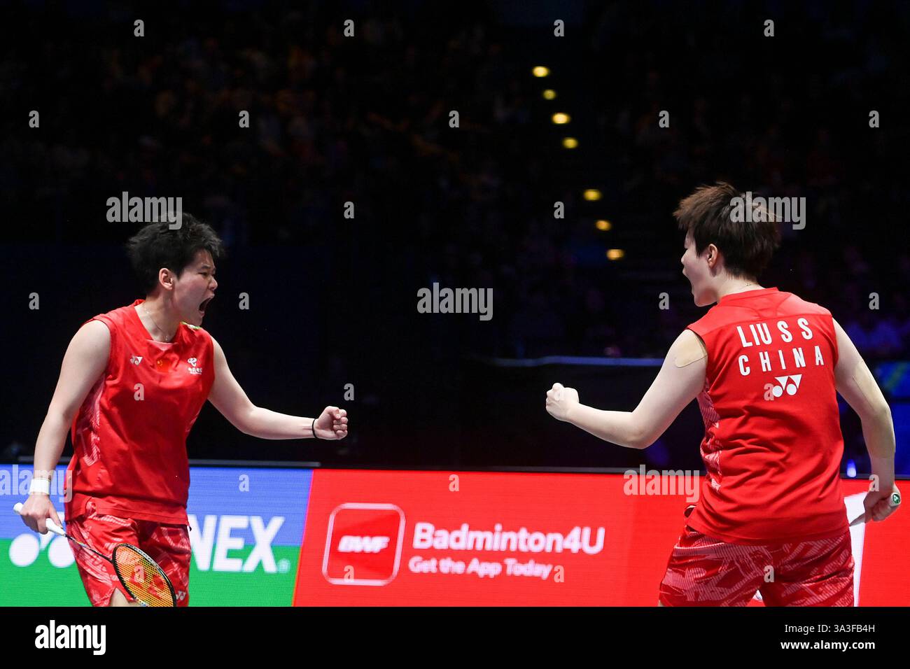 Birmingham, Britain. 15th Mar, 2025. Liu Shengshu (R)/Tan Ning react during the women's doubles ...