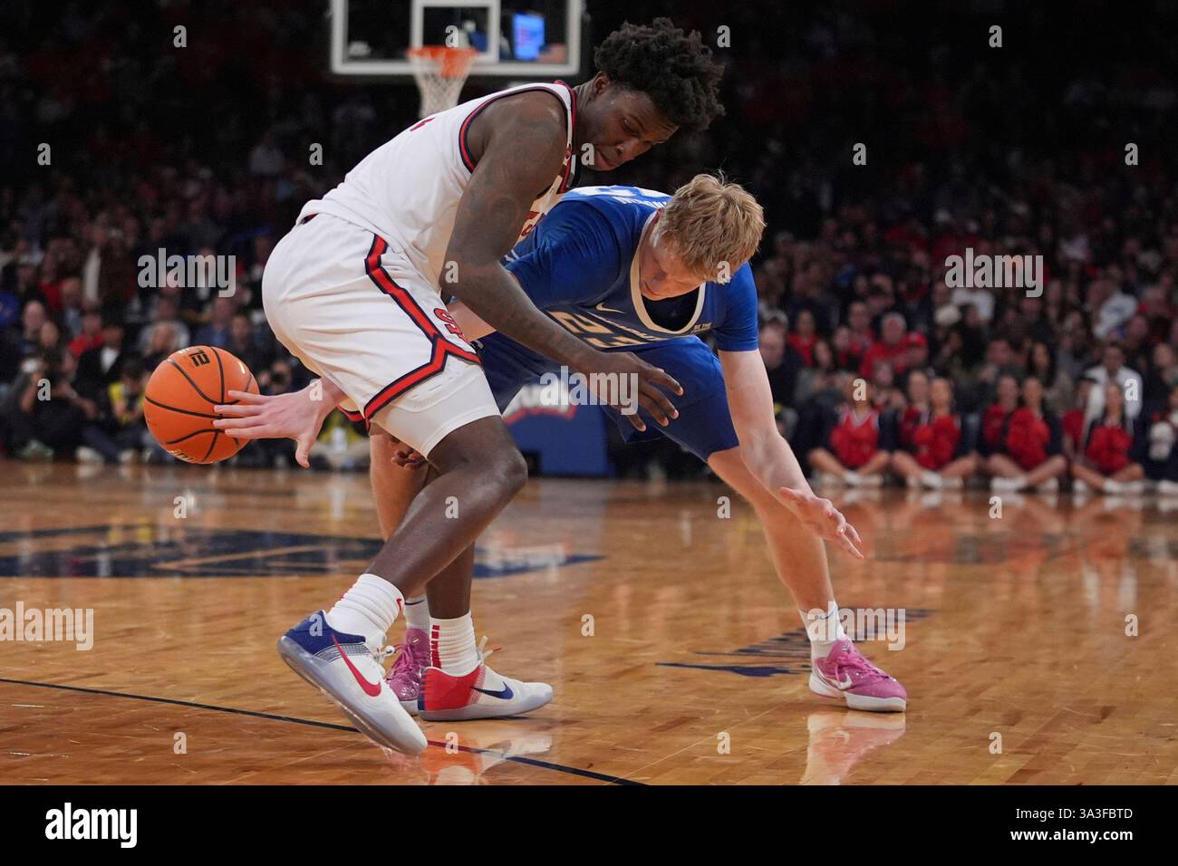 Creighton's Jackson McAndrew, right, loses control of the ball as St ...