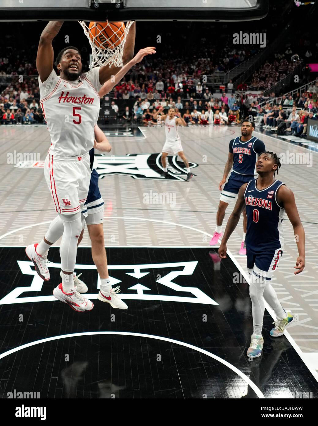 Houston forward Ja'Vier Francis (5) dunks the. Ball during the second ...