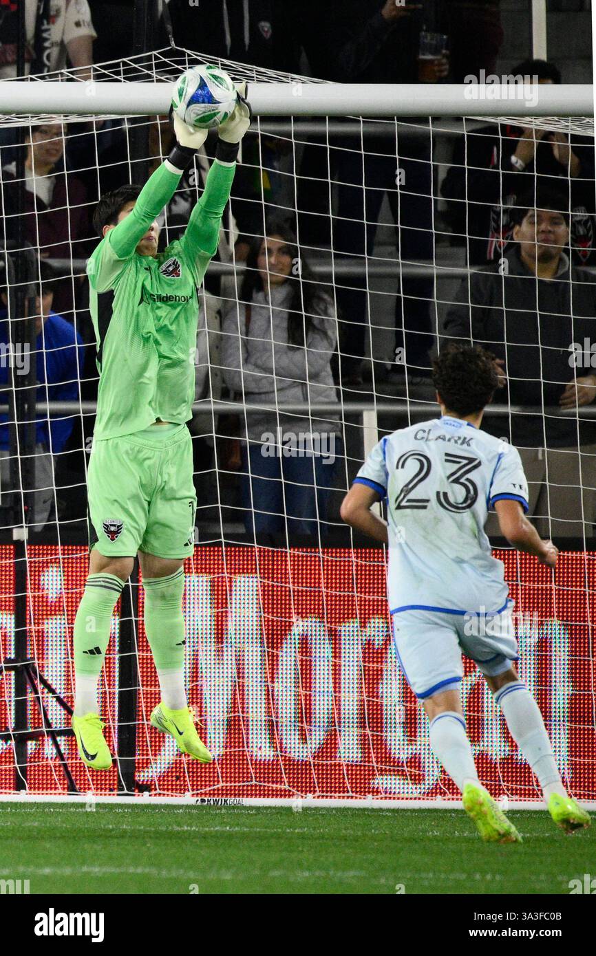 D.C. United goalkeeper Kim Joon-Hong, left, stops the ball next to CF ...