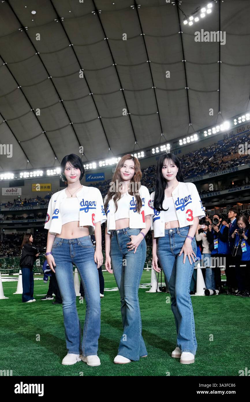 Members of MISAMO, a subunit of the K-pop girl group TWICE, pose for photos on the field before ...