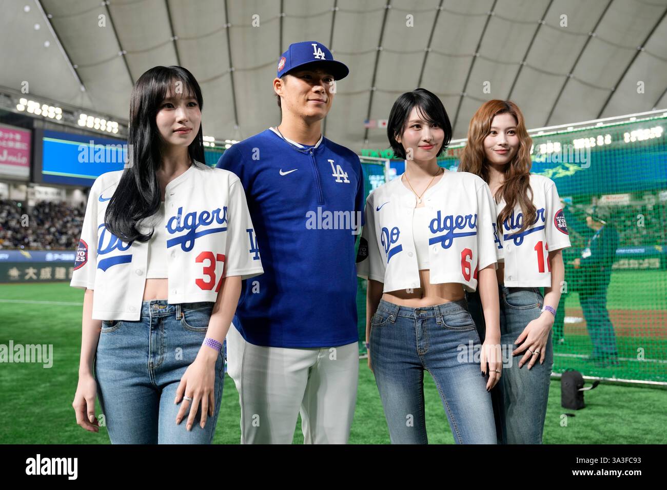 Los Angeles Dodgers pitcher Yoshinobu Yamamoto, middle left, poses for photos with members of ...