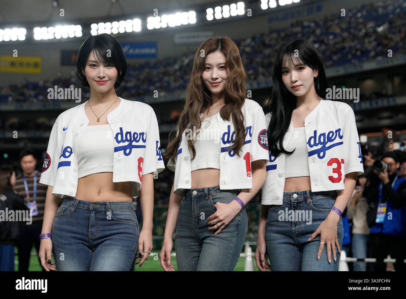 Members of MISAMO, a subunit of the K-pop girl group TWICE, pose for photos on the field before ...
