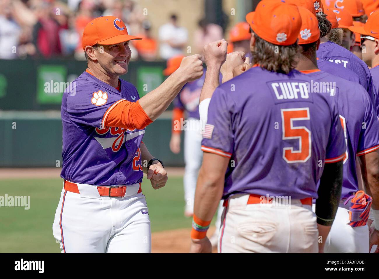 Head coach Erik Bakich (23) of the Clemson Tigers high-fives players ...