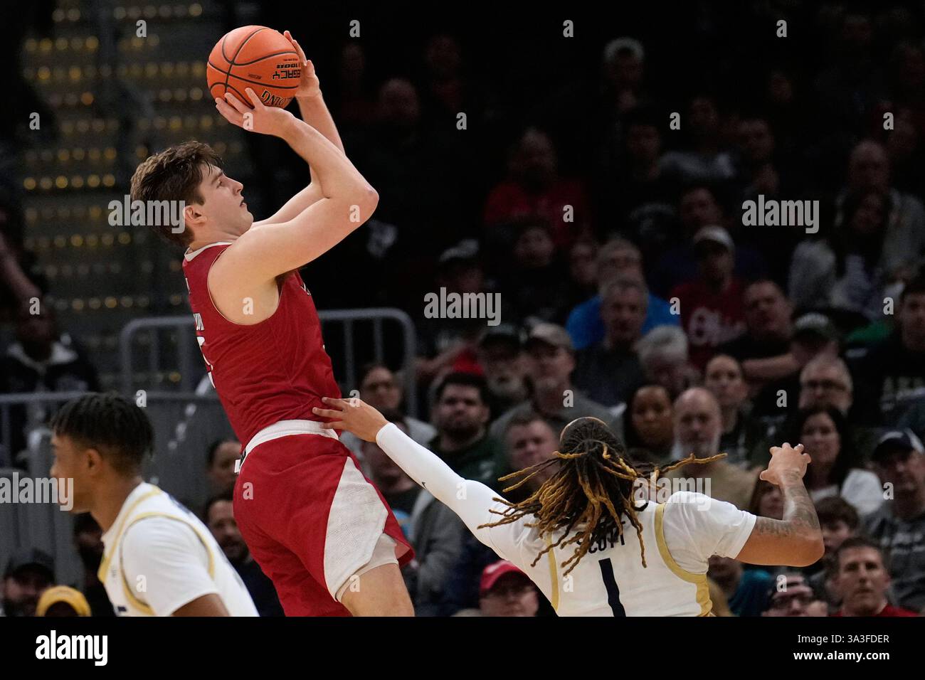 Miami (Ohio) guard Peter Suder, left, shoots over Akron guard Shammah ...