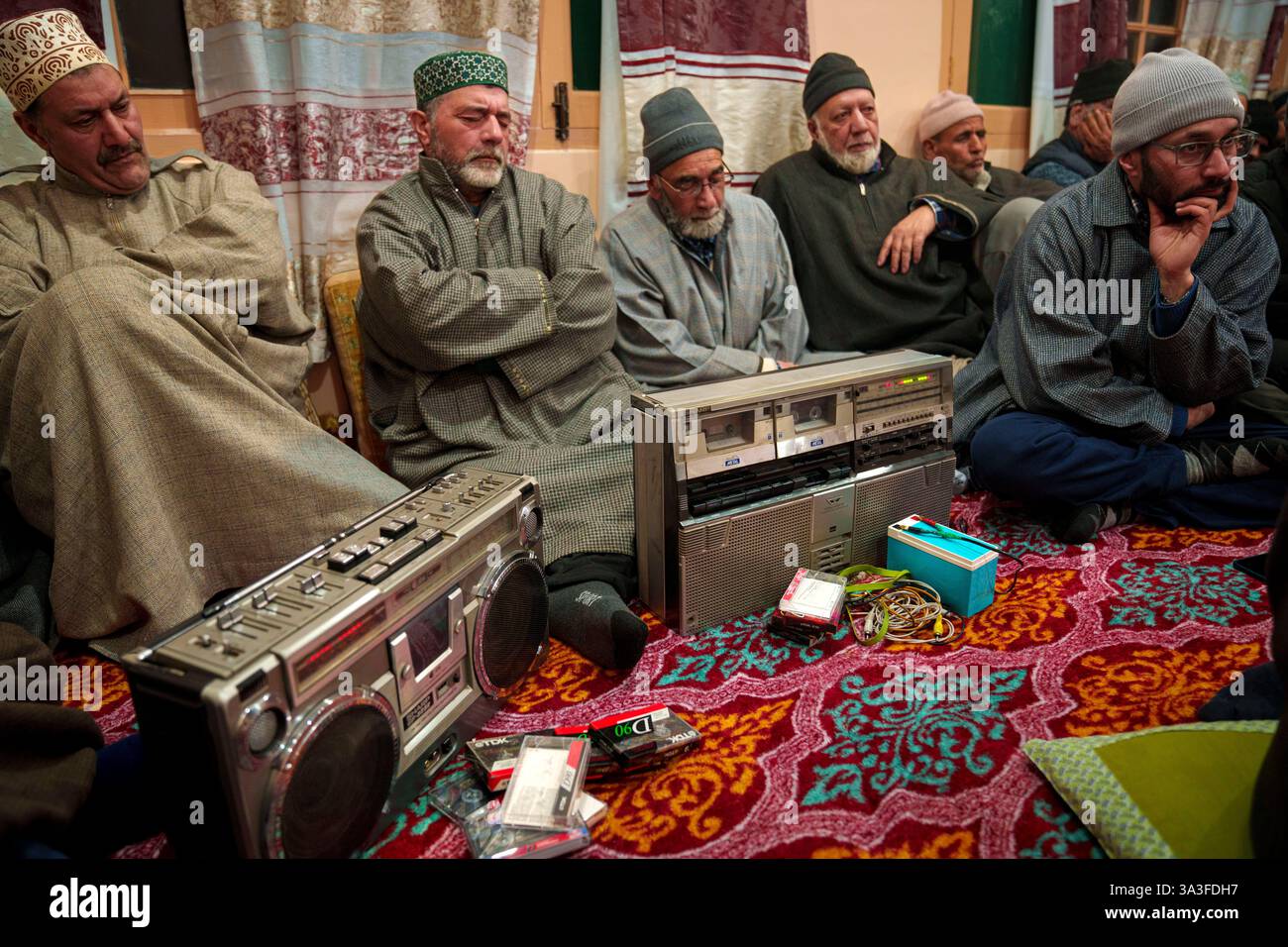 Kashmiri men listen Sufi songs on a tape recorder during a Sufi ...