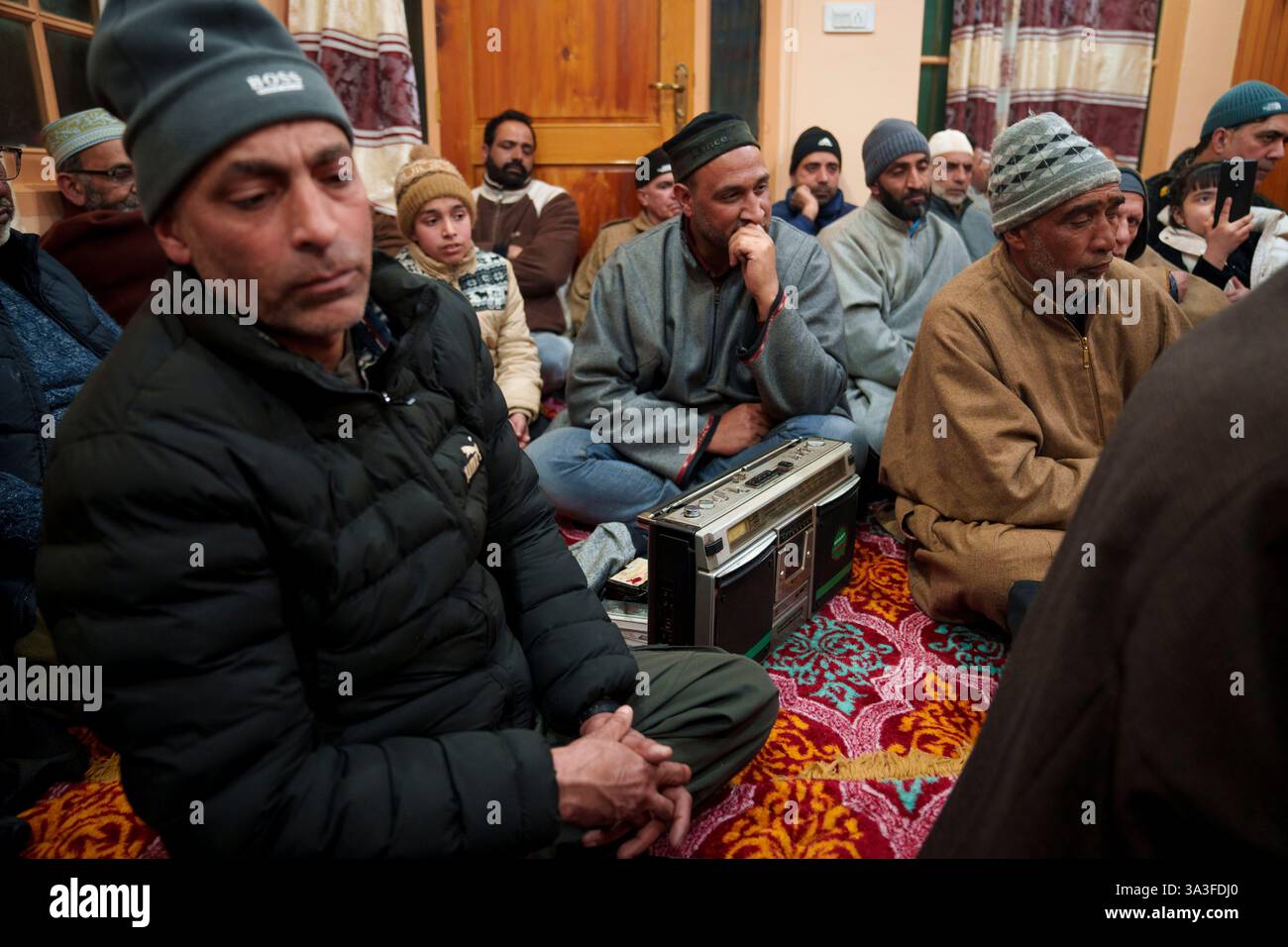 Kashmiri men listen Sufi songs on a tape recorder during a Sufi ...