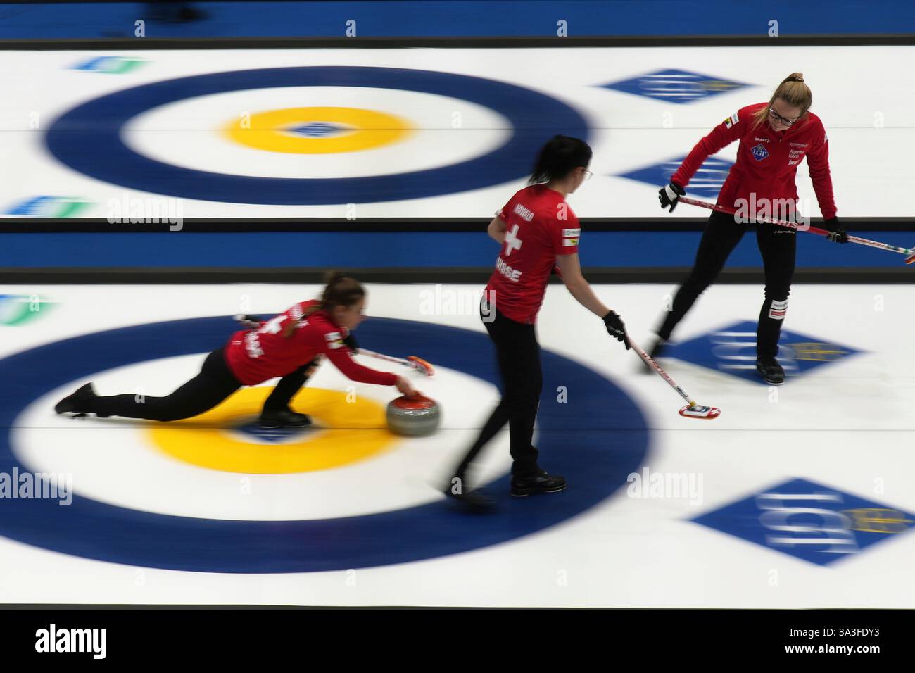 Switzerland's Selina Witschonke, left, releases the stone against China ...
