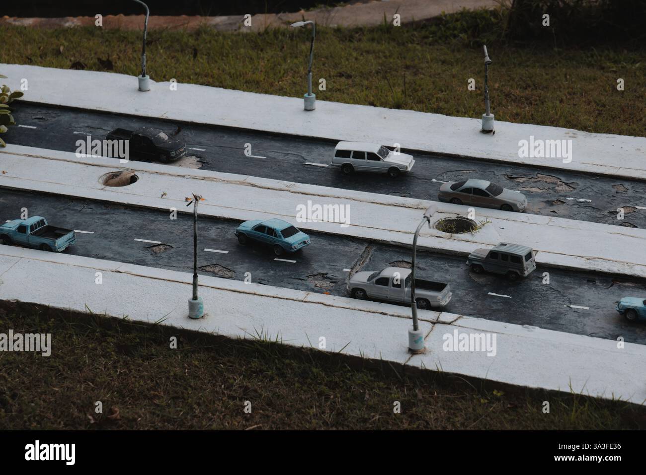 A Miniature Traffic Scene featuring Model Cars placed meticulously on a ...