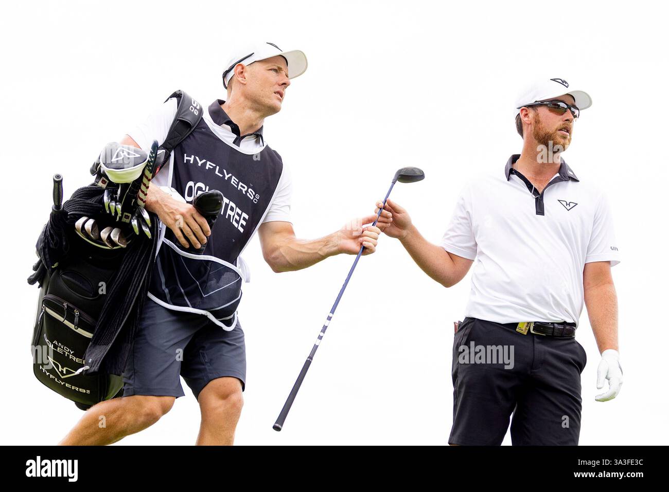 Andy Ogletree of HyFlyers GC and his caddie, Devin Stanton, walk off ...