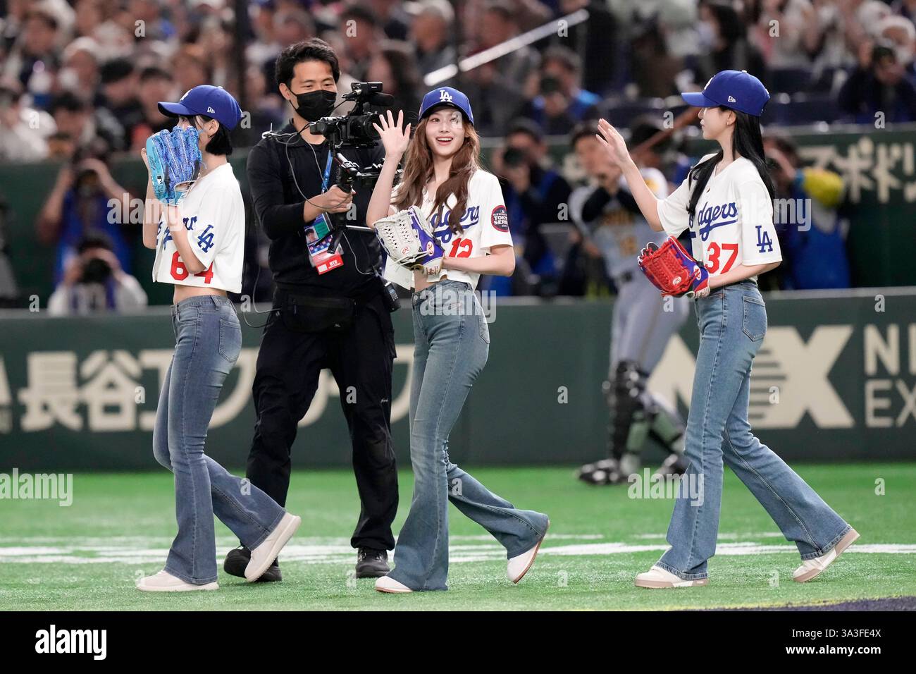 Members of MISAMO, a subunit of the K-pop girl group TWICE, walk off the field after the ...