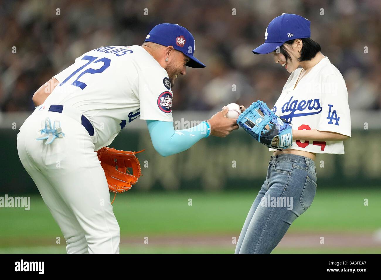 Los Angeles Dodgers' Miguel Rojas, left, greets a member of MISAMO, a ...