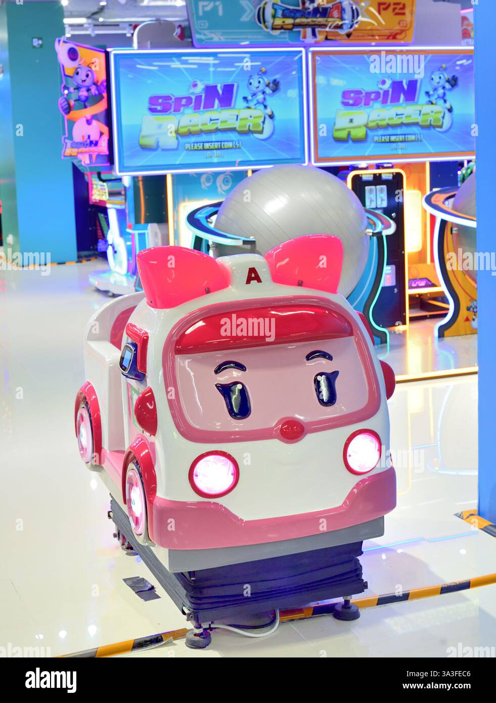 Indoor kiddie ride game machine bus in game parlor Stock Photo - Alamy