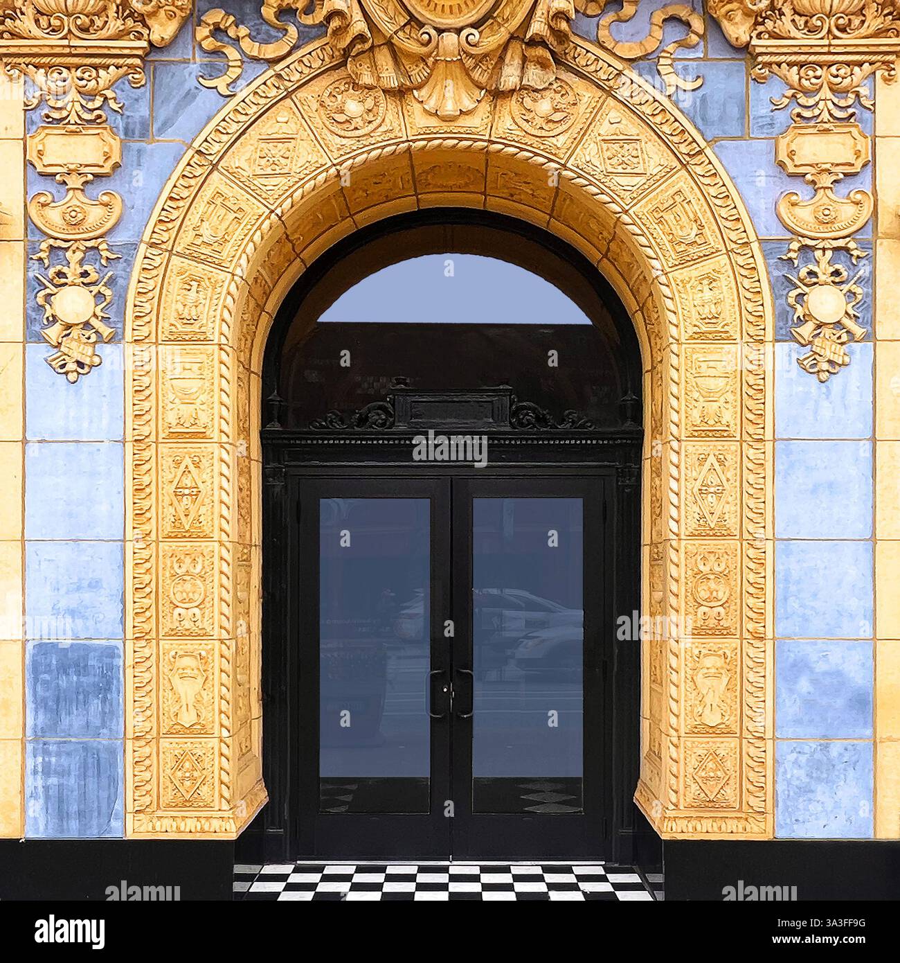 An ornate arched entrance with arched doors, surrounded by intricate ...