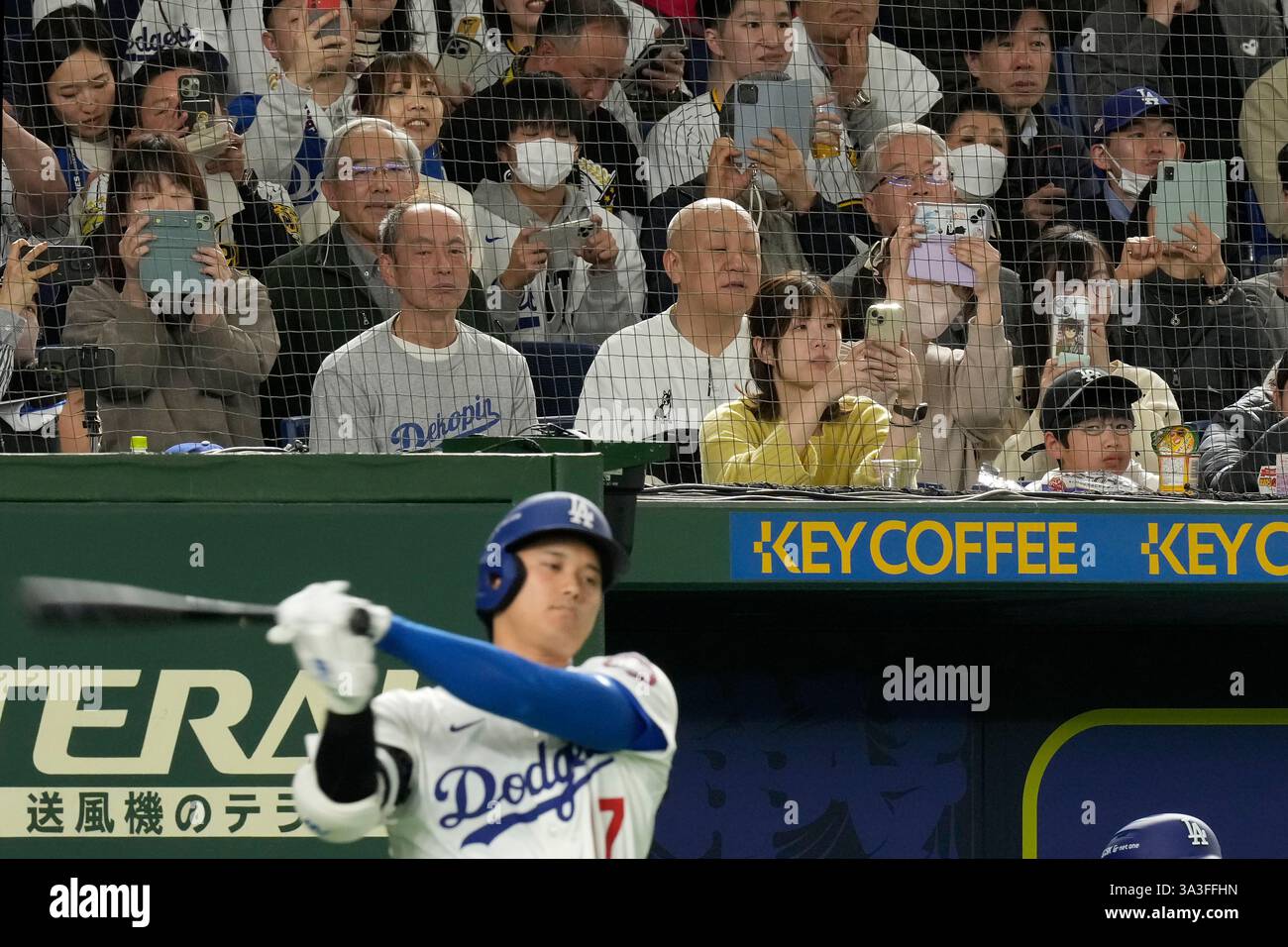 Fans watch as Los Angeles Dodgers' Shohei Ohtani, bottom, swings in the ...