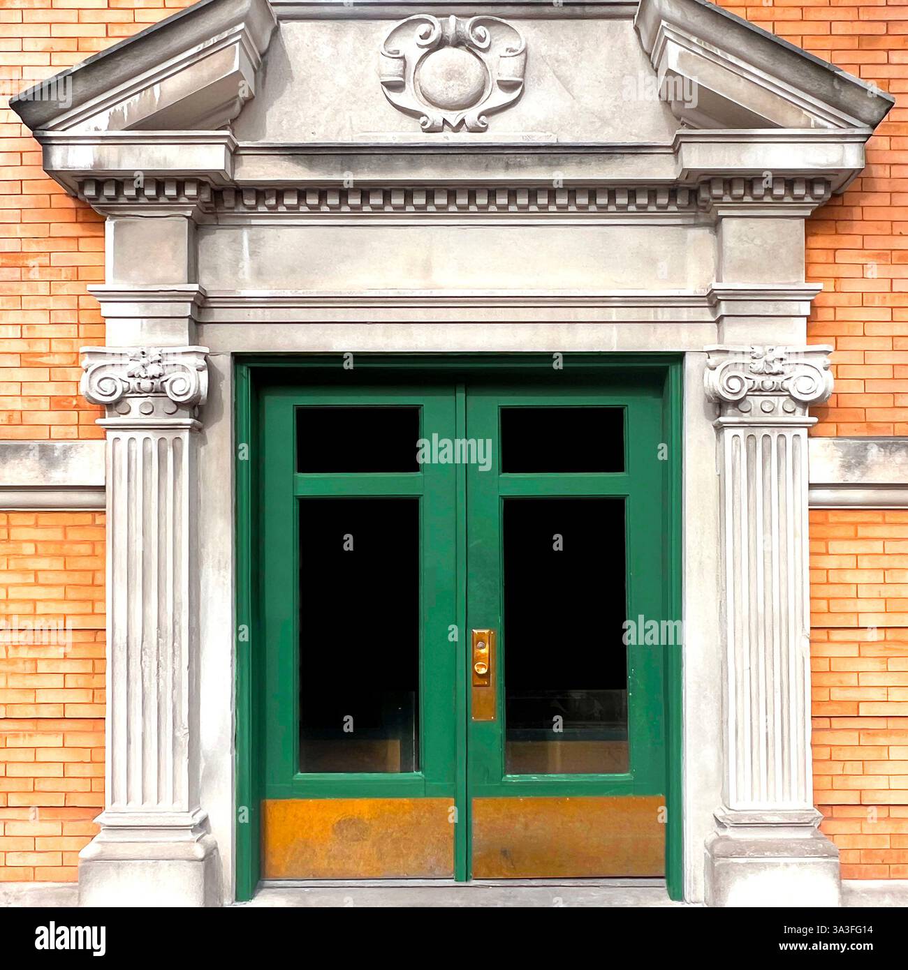 Neoclassical entrance featuring green double door framed by fluted Corinthian columns and an ...